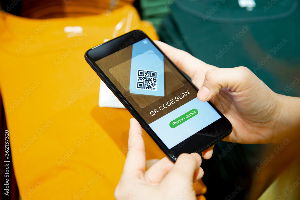 Smart retail concept.Woman scanning QR code for product details in ...