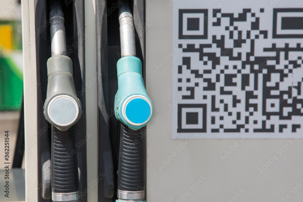 Zdjęcie Stock: Petrol pump filling nozzles and QR code are on gas ...