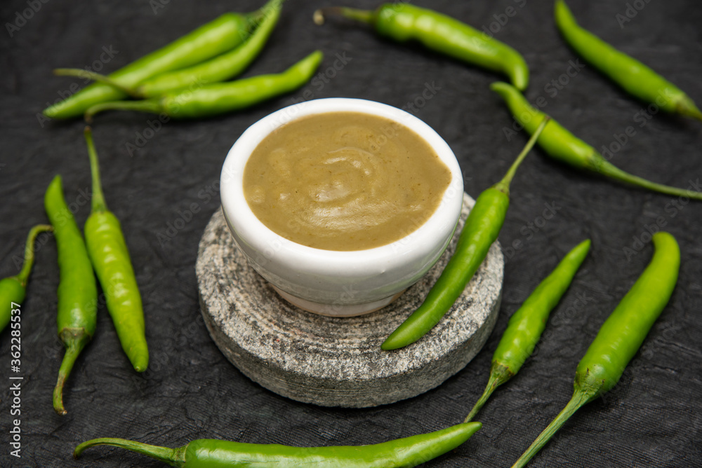 Green chili sauce With green pepper Isolated on dark black background ...
