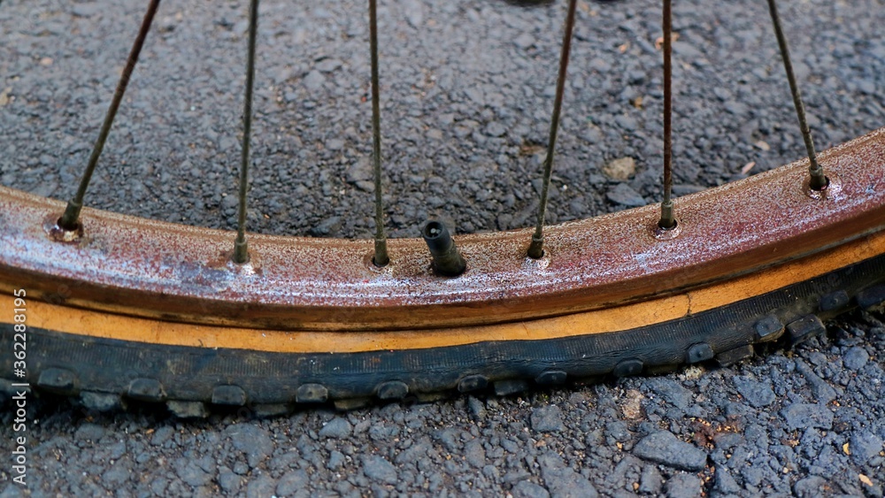 old Bicycle wheel with flat tyre on the asphalt Stock Photo | Adobe Stock