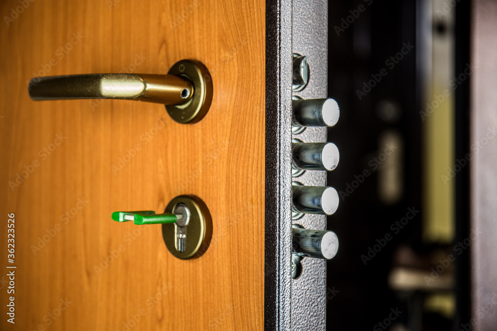Armored front door, security lock with key. Home security Stock Photo ...