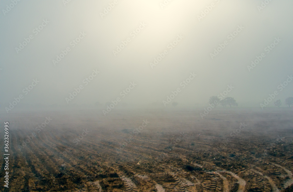 Foggy agricultural fields. Land is left for winter as ploughed land ...