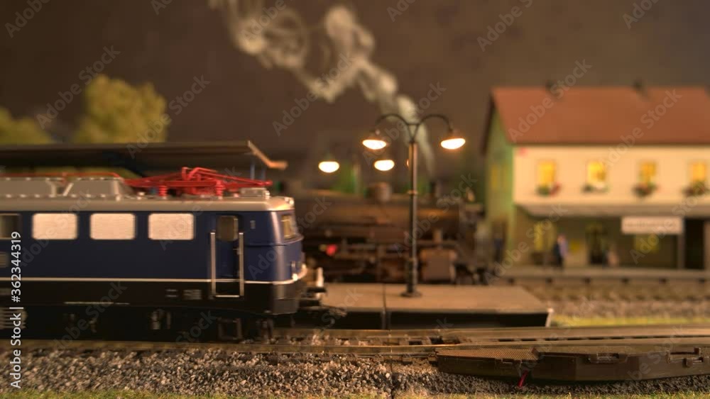 Toy diesel train on model railway station. Model of rail station. Rail ...