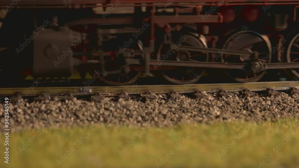 Close up model of toy locomotive moving on railroad. Vintage model of ...
