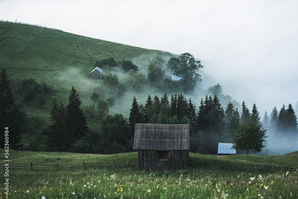 Beautiful view of small cabin surrounded by inversion fog in the ...
