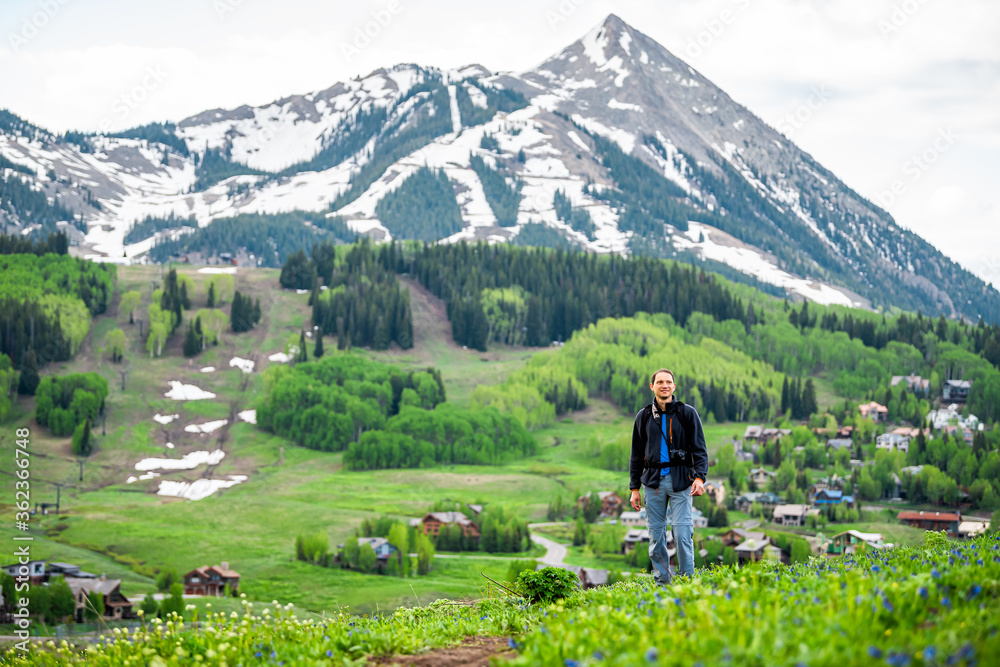 Man standing far distant hiking on Snodgrass trail with view of Mount ...