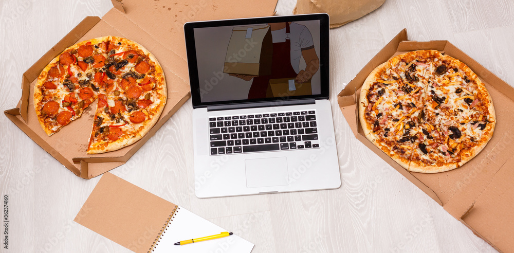 food order concept. Close-up top view of a ordering pizza with a laptop ...