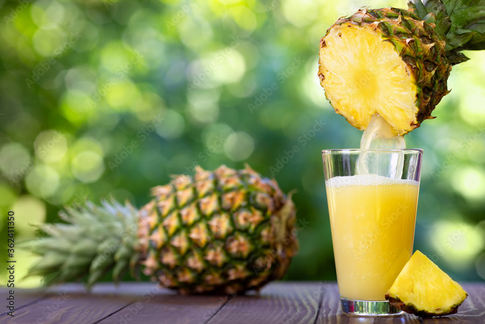 pineapple juice pouring into glass Stock Photo | Adobe Stock