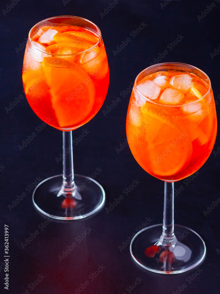 Aperol spritz cocktail in glass on dark background. Two glasses of ...