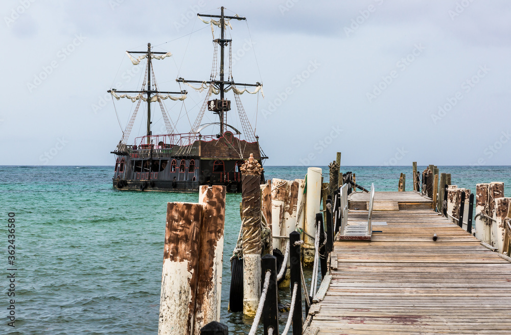 dramatic seascape image of aqua blue caribbean water with a pirate ship ...