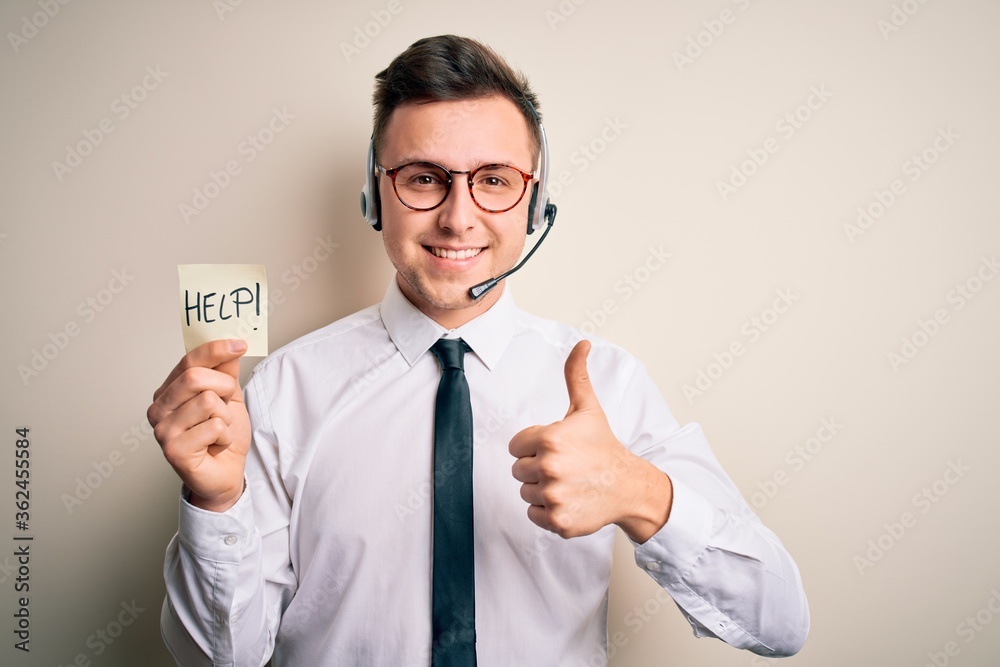 Young call center operator man wearing headset holding paper note with ...