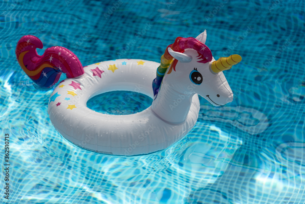 Inflatable unicorn floating in swimming pool. Unicorn inflatable pool ...