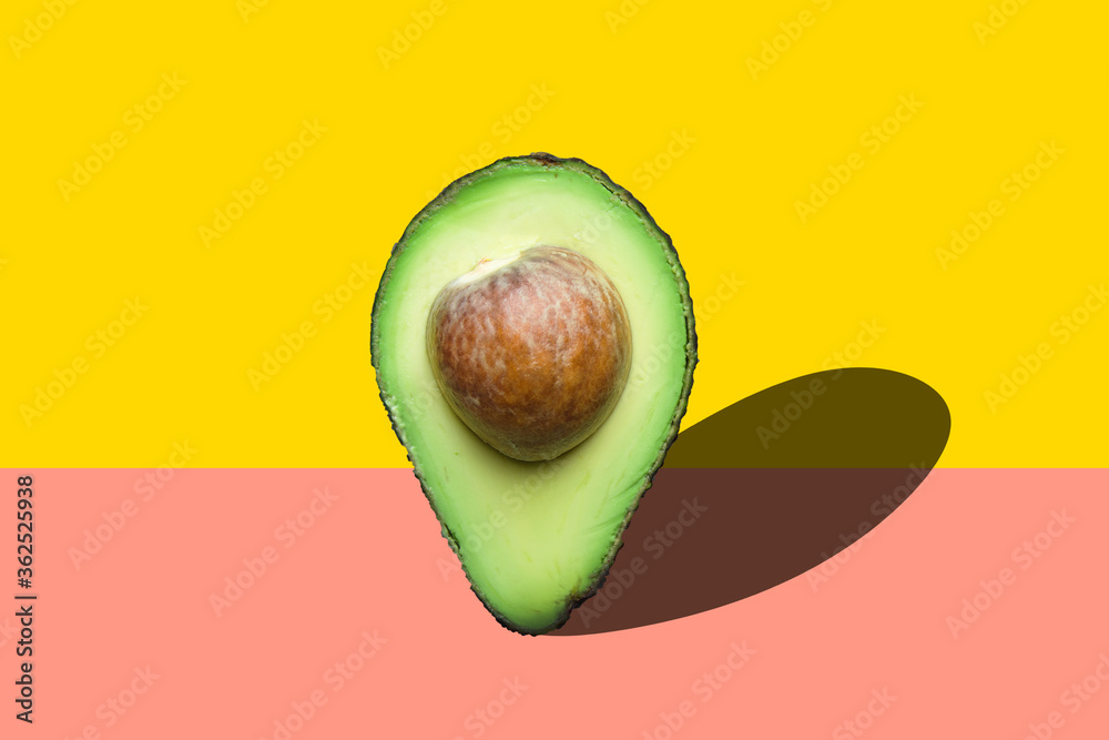 Raw ripe halved avocado with pit imitating map pointer with drop shadow ...