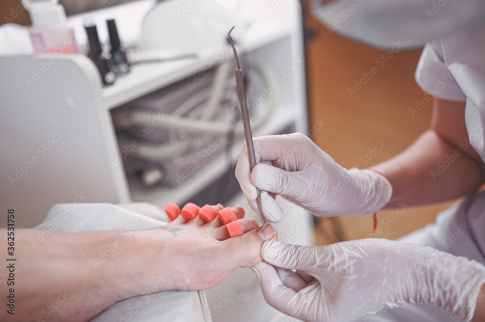 Professional medical pedicure procedure close up using double nail ...