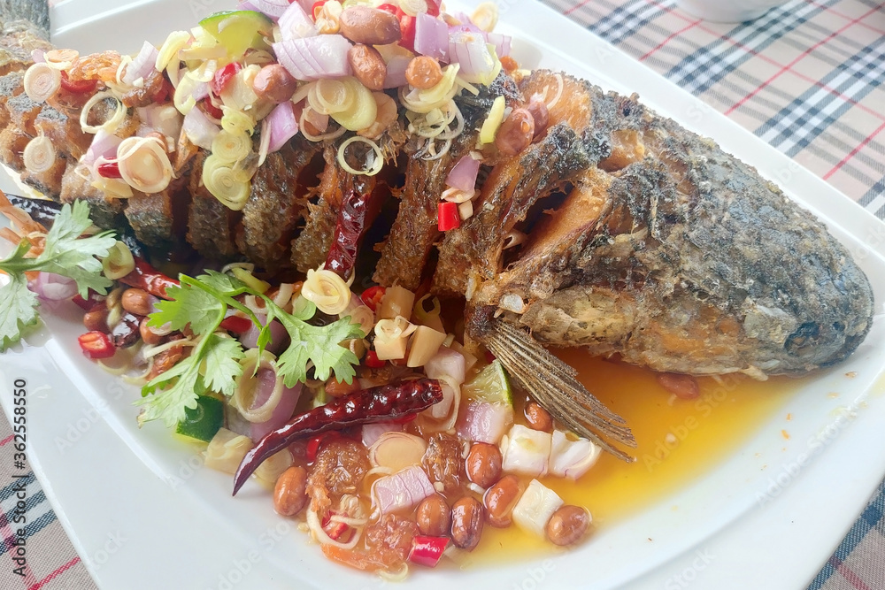 fried Snakehead fish with herb and spicy sauce, thai food. Stock Photo ...