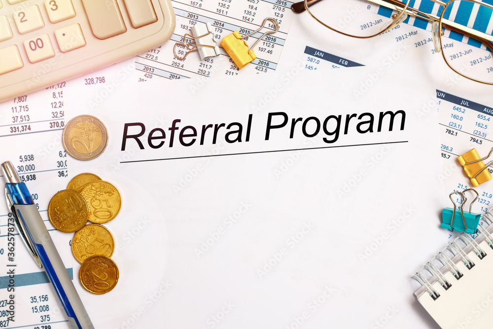 Desktop office desk, notebook, glasses, pen and documents with Referral ...