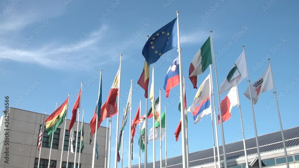 Flags flying united, different flags on blue sky background, Flags of ...