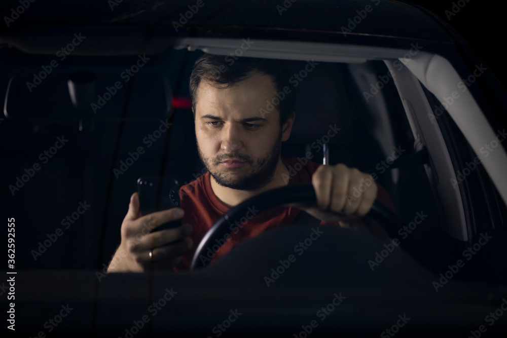 Unshaven confident serious young millenial male driver sits at steering ...