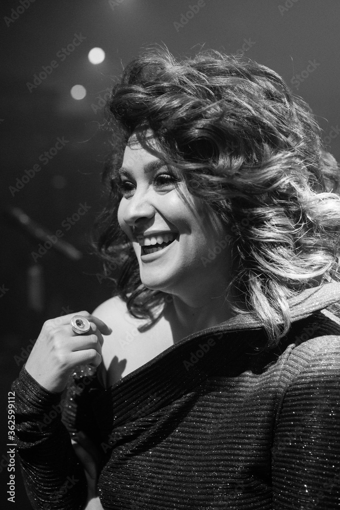 Young beautiful actress woman on stage under the spotlights. Stock ...