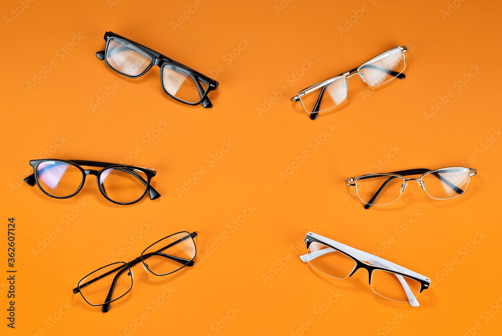 Different types of glasses on an orange background close up. Glasses ...