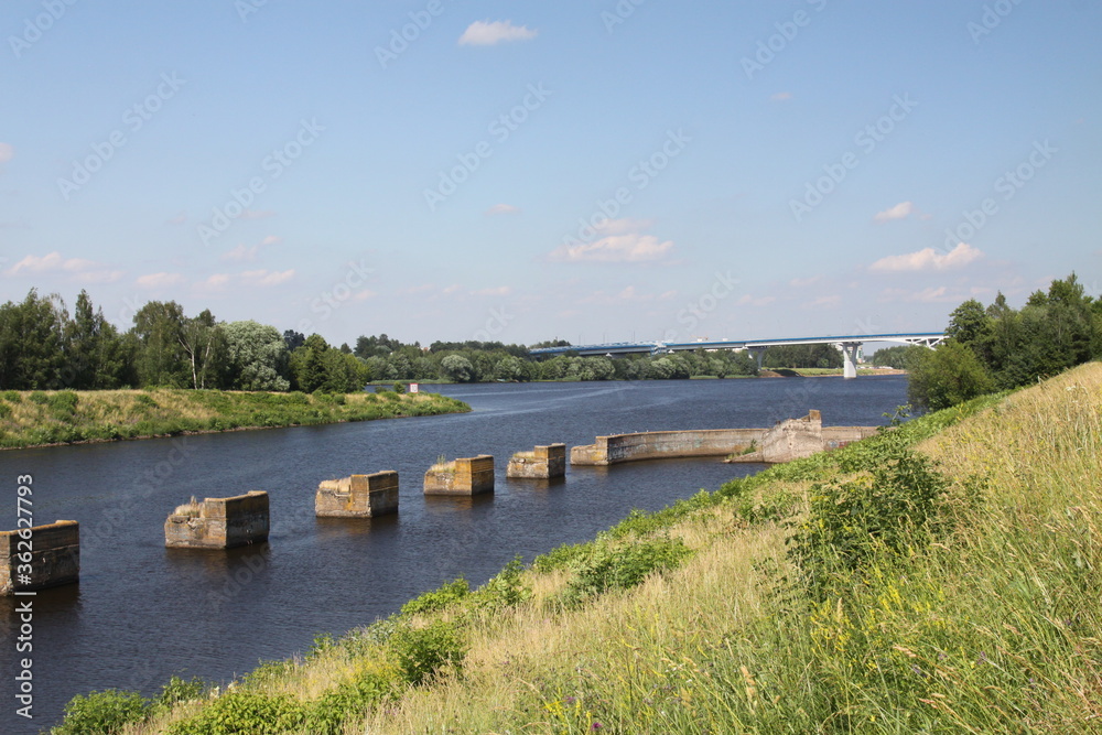 Massive concrete piers of the former pier, water surface of the river ...