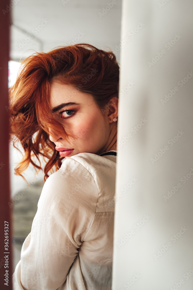 Rear view of young woman looking over her shoulder to camera. Model ...