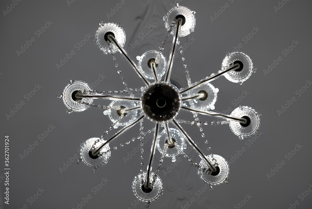 Ceiling chandelier bottom view, light reflection in the glass faces of ...