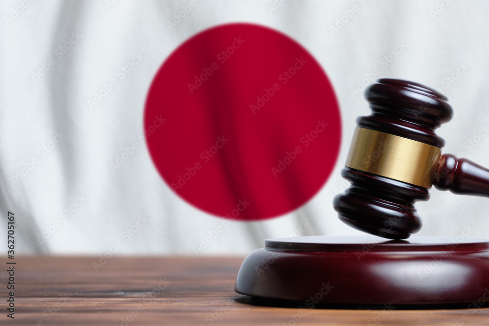 Justice and court concept in Japan. Judge hammer on a flag background ...