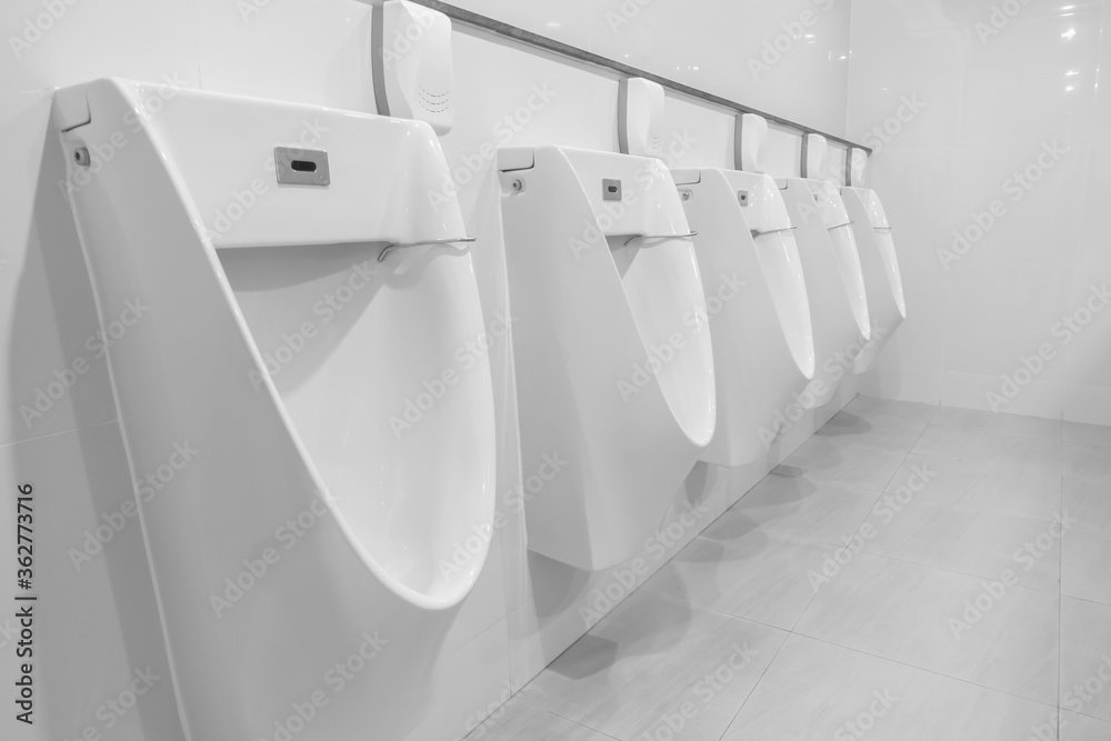 Automatic urinals in the men's bathroom. Automatic cleaning system in ...
