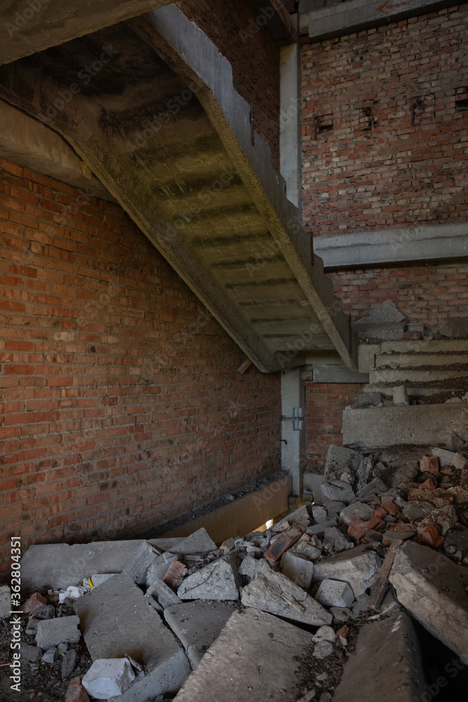 A ruined, crumbling staircase in an abandoned building. A flight of ...