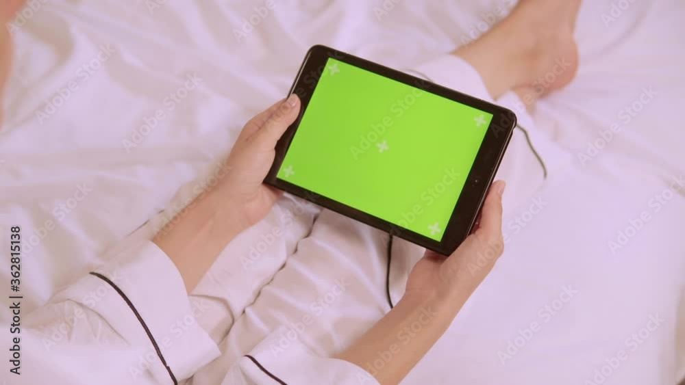 top view female use touch screen device with green screen chat online ...