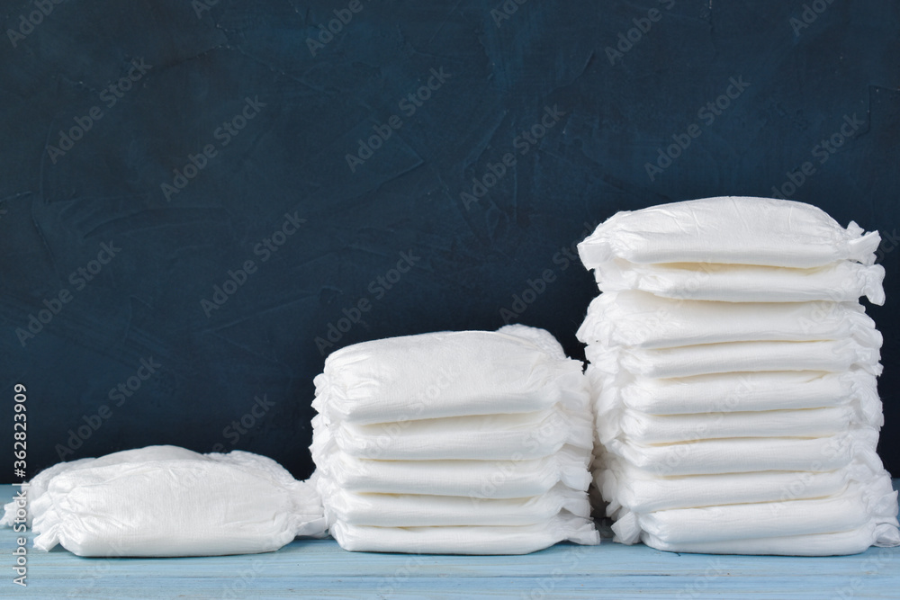 Three stacks of diapers on a blue background with copy space Stock ...