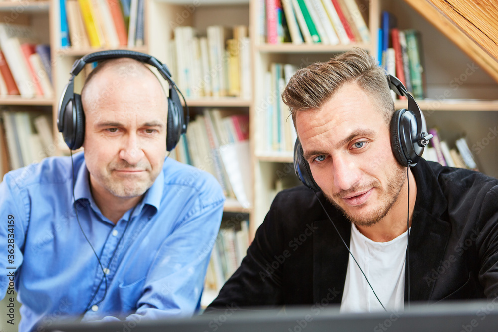 Software developers look on computer monitor Stock Photo | Adobe Stock