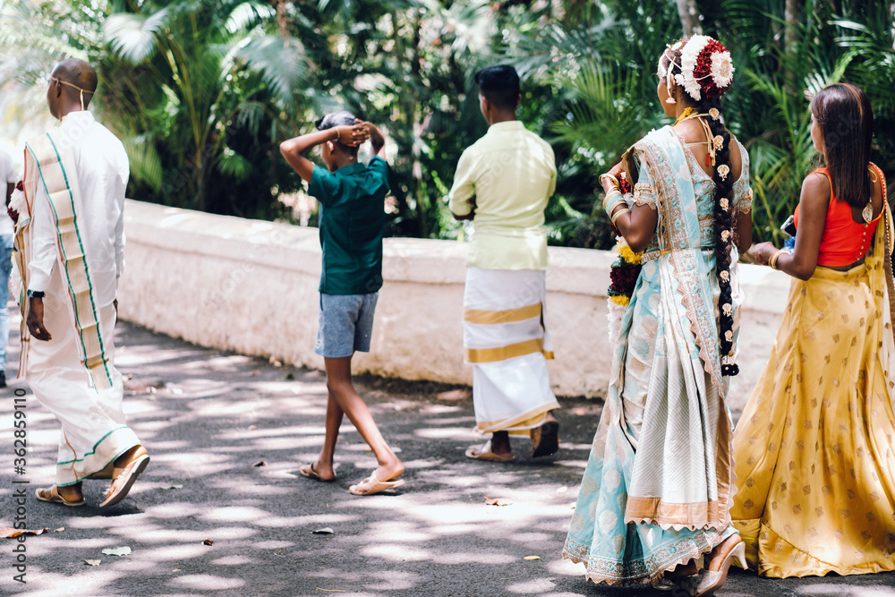 Fotografia do Stock: unrecognizable Locals in traditional outfits walk ...