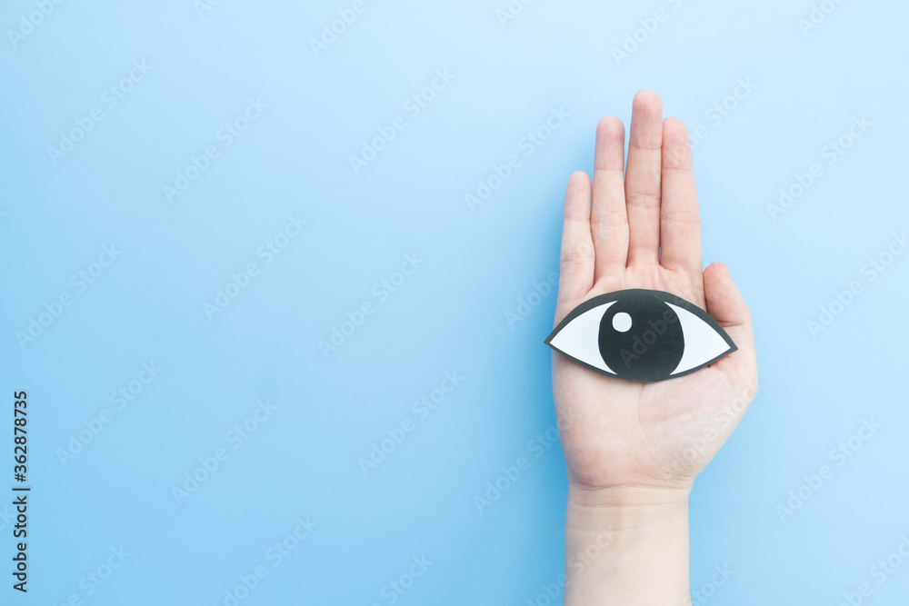 Eye care, healthy vision and ophthalmology concept. Human hand holding ...