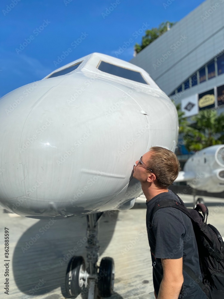 Aviation. A man stands near the plane. A man kisses the nose of a white ...