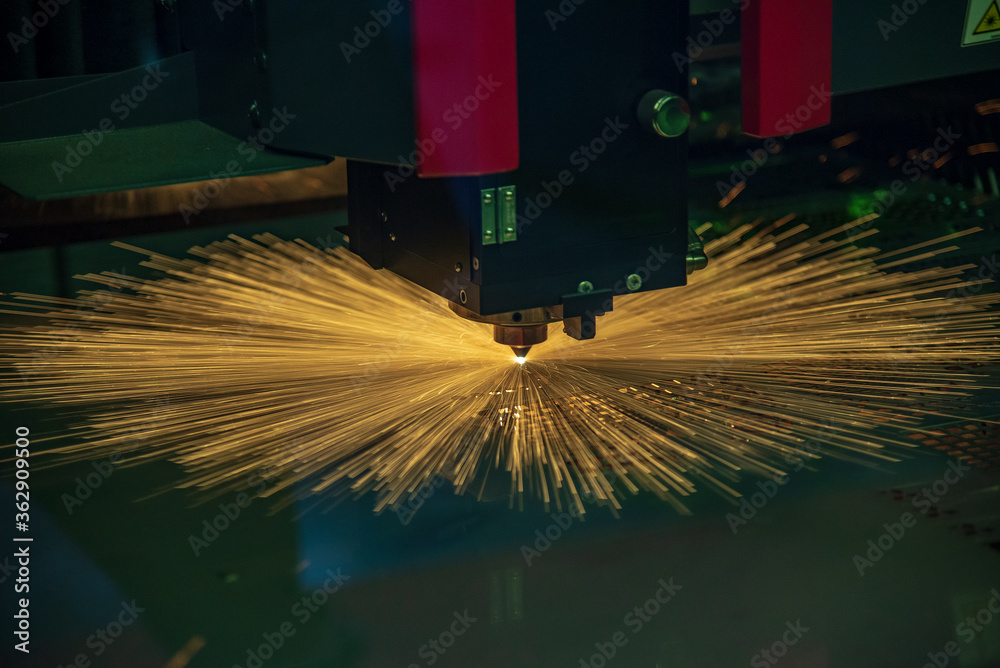 The fiber laser cutting machine cutting the sheet metal plate with the ...