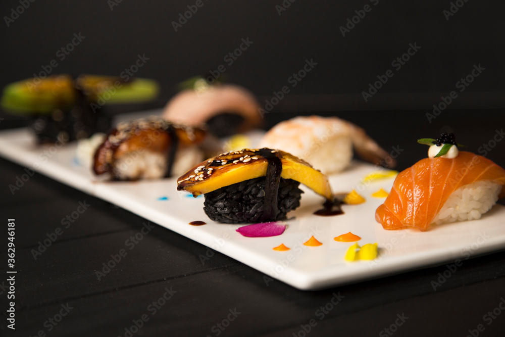 Set of Japanese nigiri. Close up of Nigiri Tamagoyaki with black rice ...