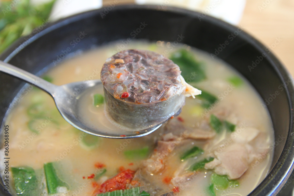 Korean pork rice soup (Dwaeji-gukbap) with the focus on rice with pork ...