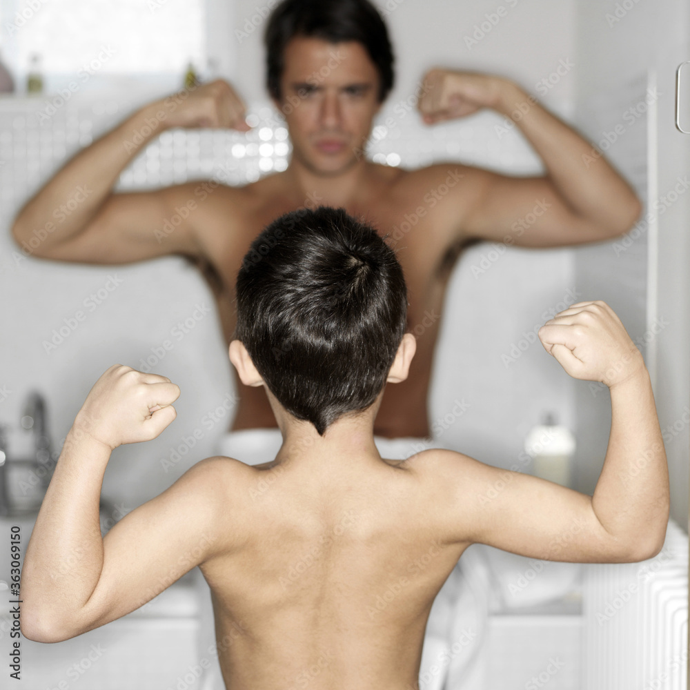Father and son showing off their muscular arms Stock Photo | Adobe Stock