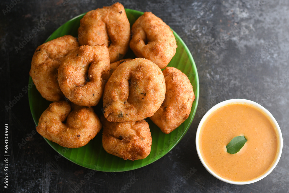 Medu Vada with tiffin sambar coconut chutney in banana leaf plate ...