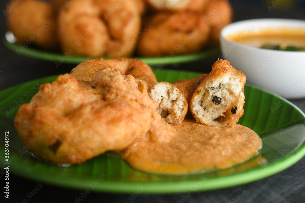 Medu Vada with tiffin sambar coconut chutney in banana leaf plate ...