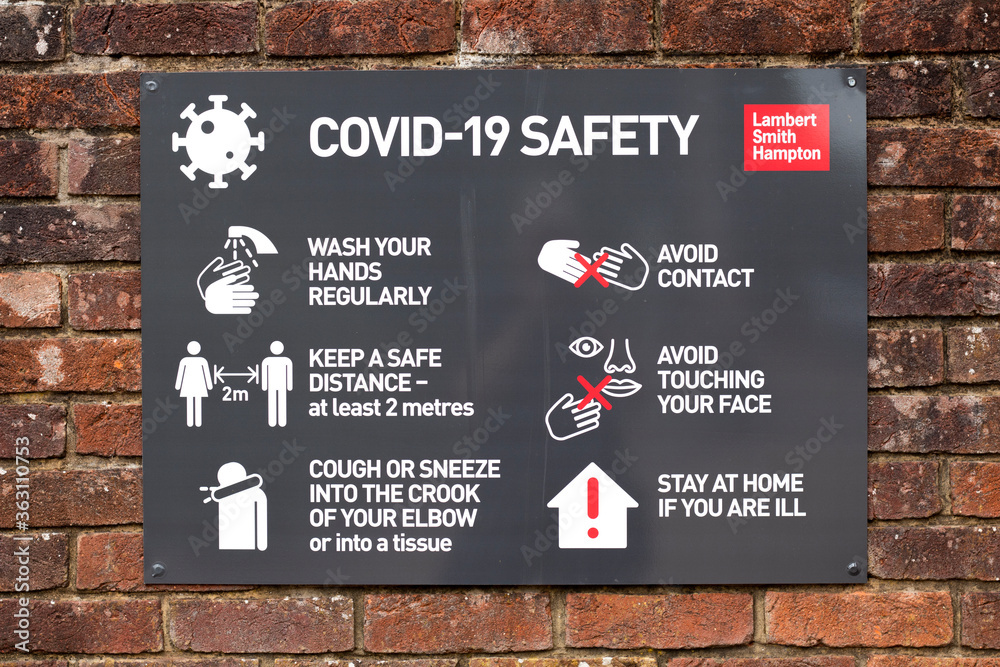 COVID 19 safety information sign for shoppers mounted on brick wall ...