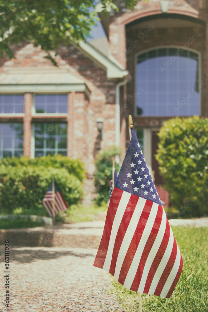 American flags displayed in the front of a southern home in honor of ...