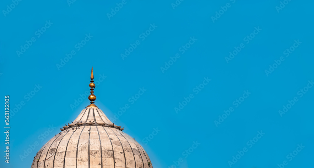 An isolated dome structure of mughal architecture with clear blue sky ...