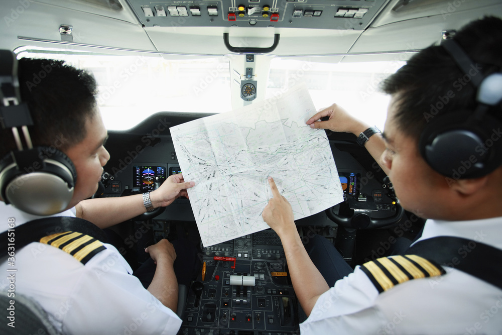 Pilot and co-pilot in private jet cockpit Stock Photo | Adobe Stock