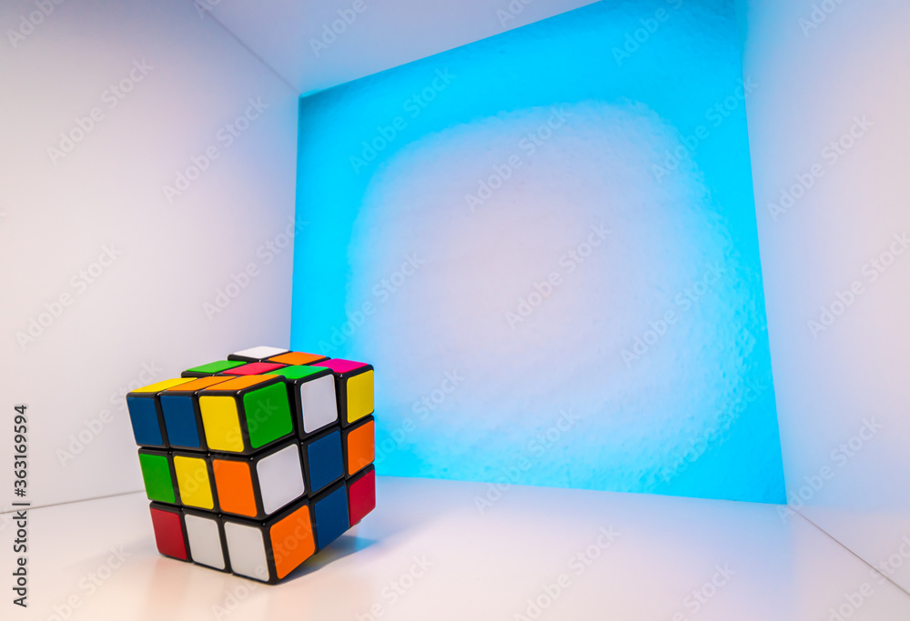 Shuffled Rubik's Cube inside a cube with light blue background Stock ...
