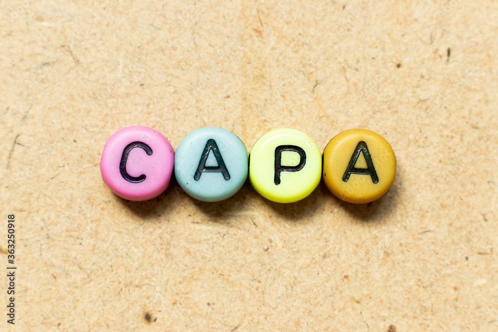 Round color bead with black letter in word CAPA (abbreviation of ...