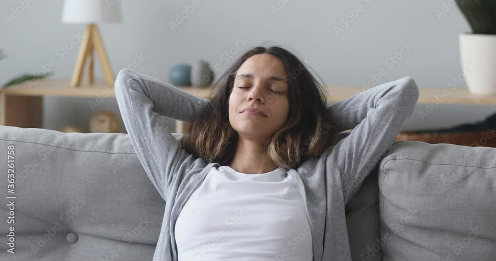 Calm serene young woman relax with eyes closed breathing fresh air ...