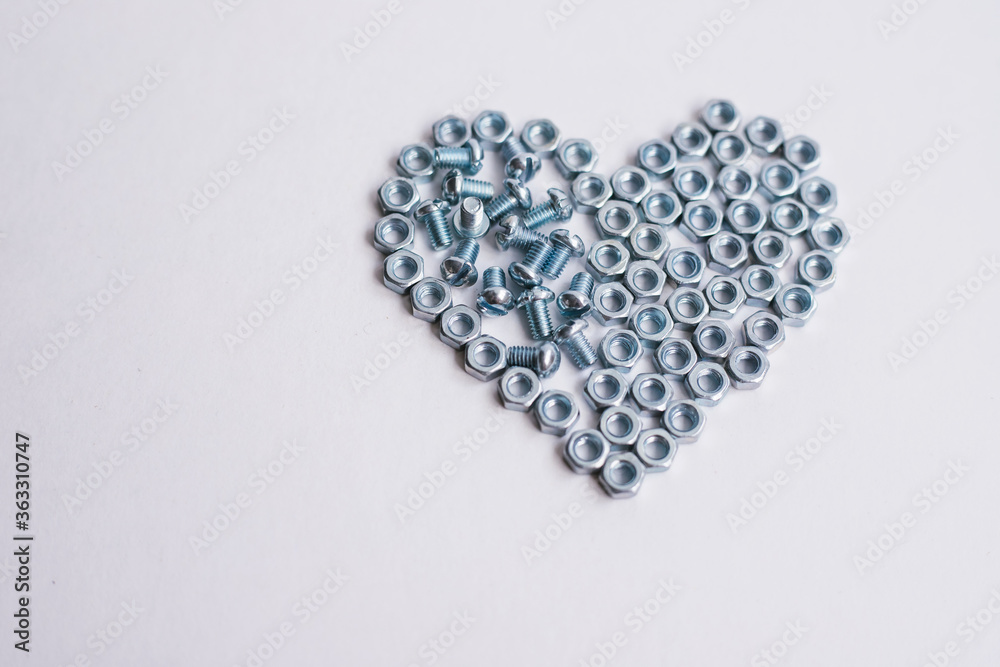 Heart laid out of bolts, nuts on a white background. Father's Day and ...
